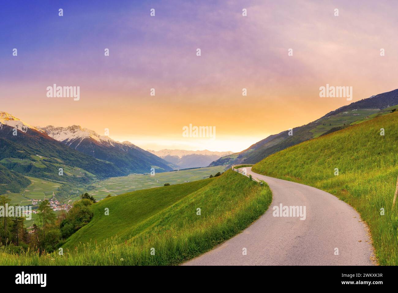 Mountain panorama of a small road in the South Tyrolean Alps, sunset ...