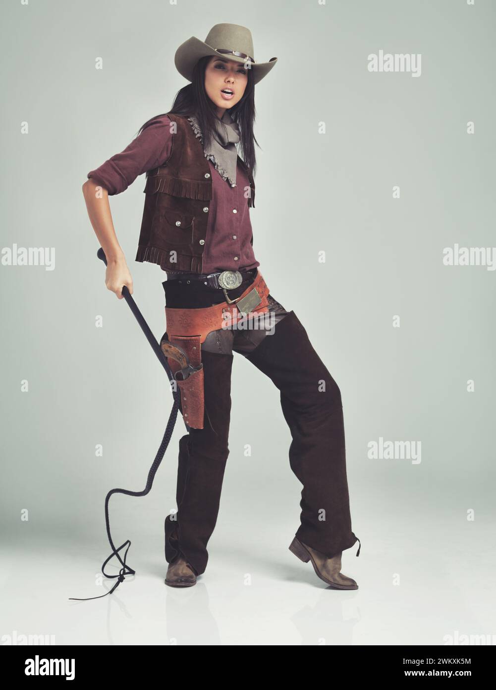 Woman, cowgirl and portrait in studio for outfit costume with ...
