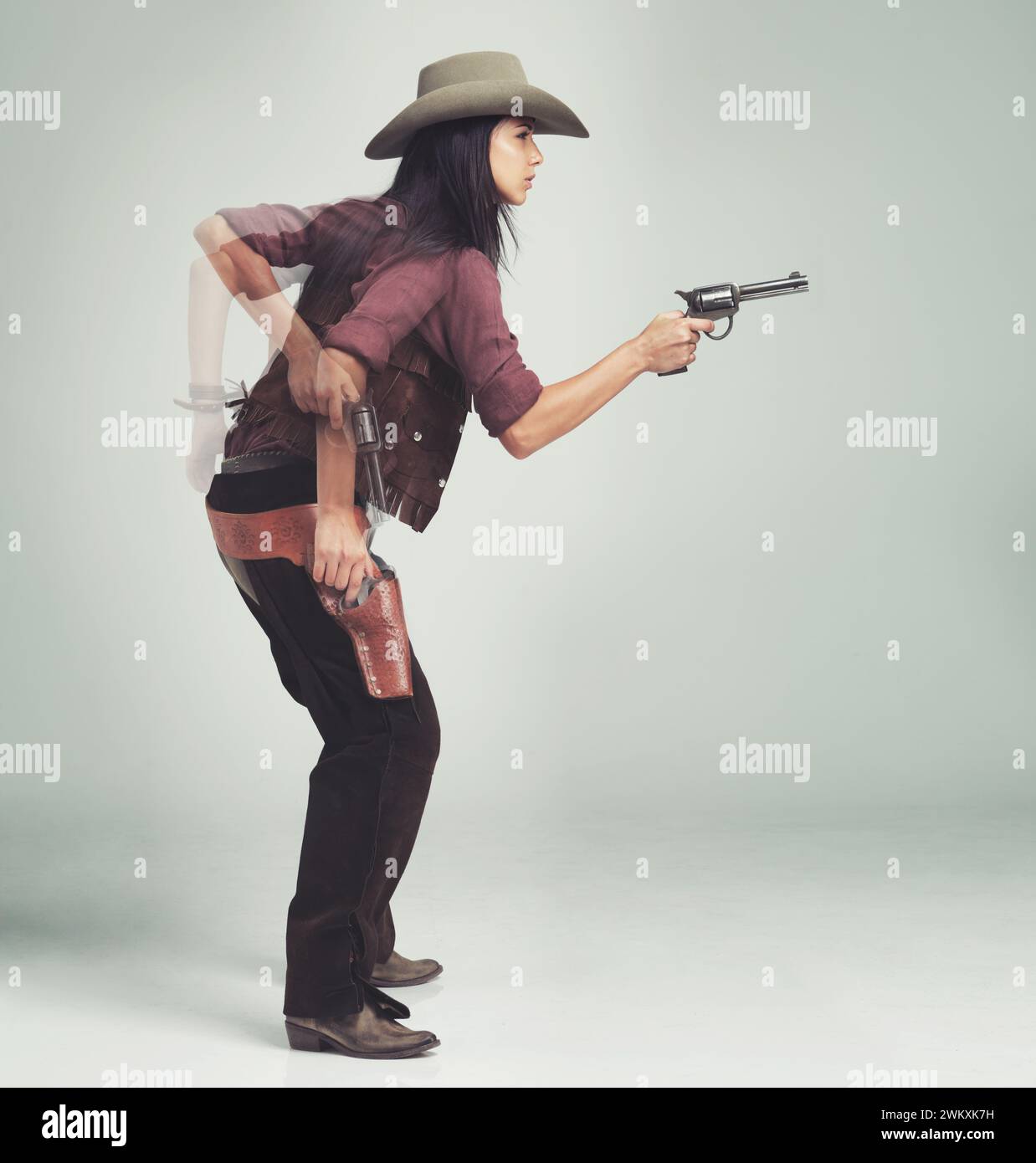 Western, cowboy and woman with gun in studio for motion, speed and ...