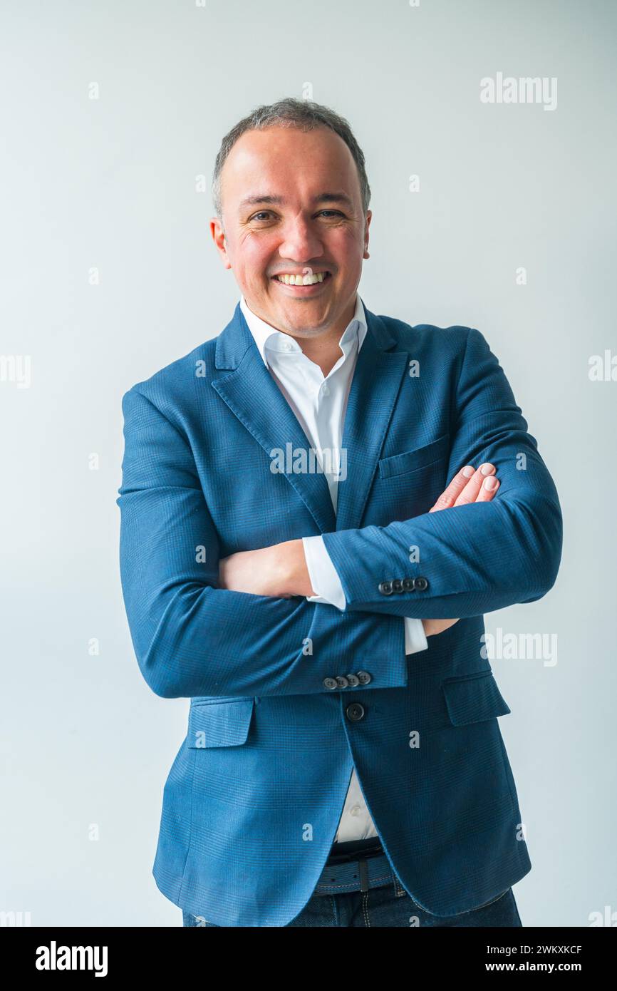 Vertical three quarter length studio portrait of a confident ...