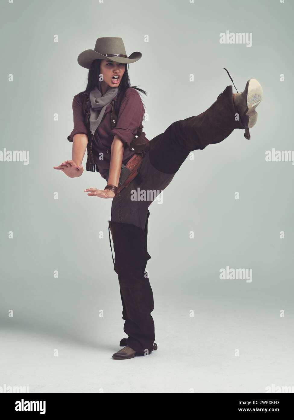 Western, woman and cowboy in studio with fashion, leg up and gesture to ...