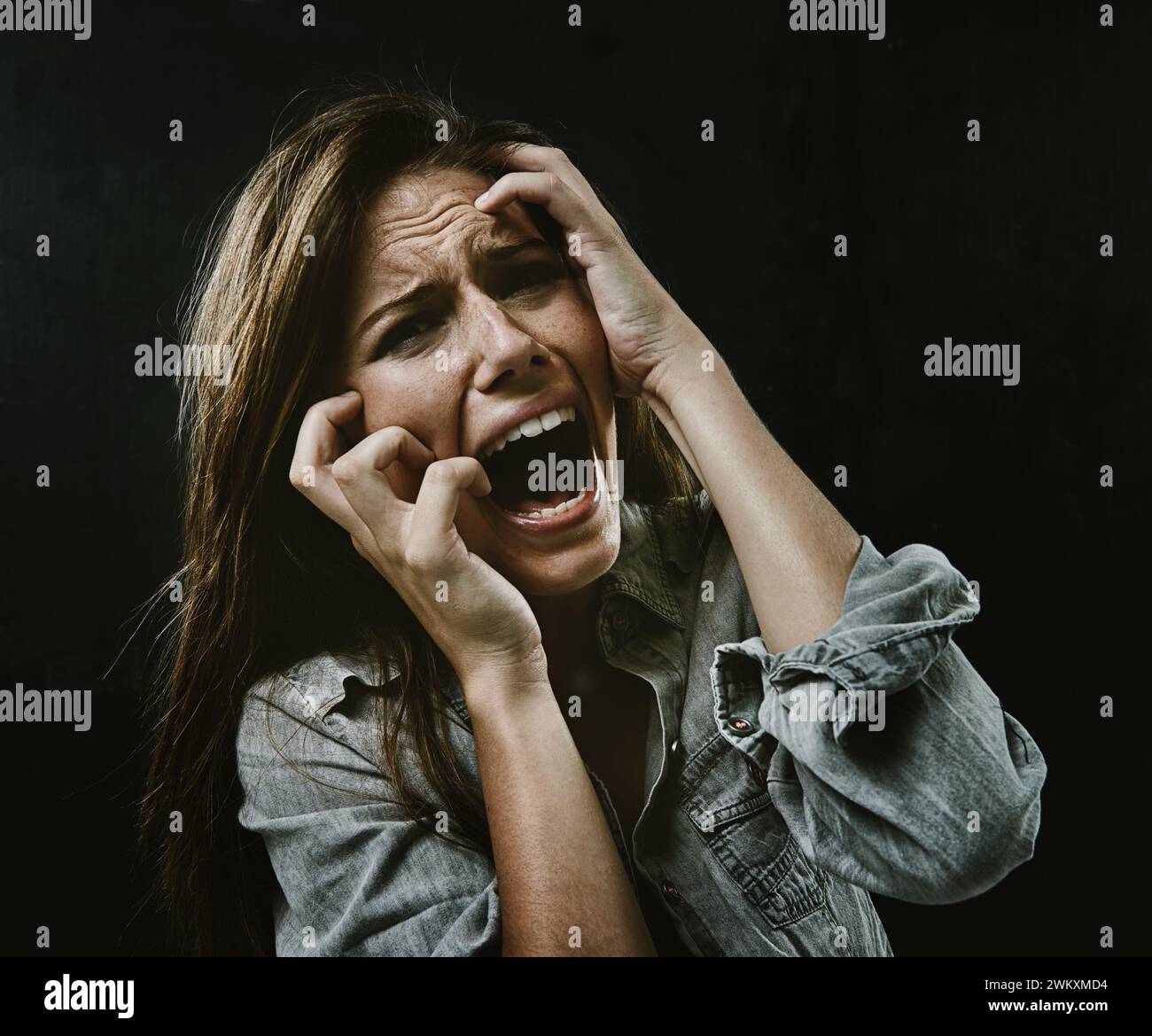 Portrait, mental health and horror with woman screaming in studio on ...