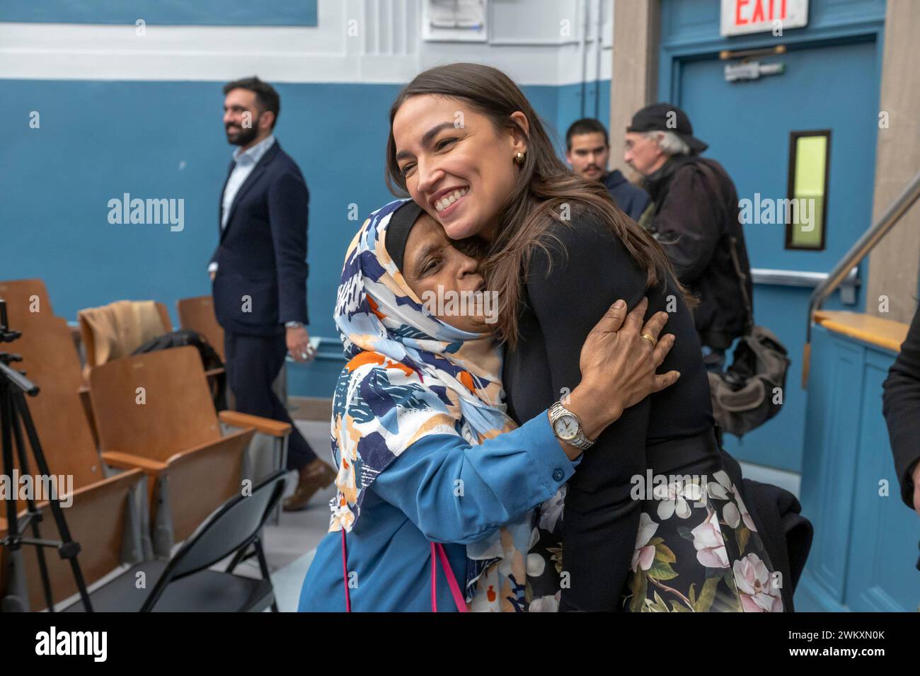 Rep. Alexandria Ocasio-Cortez (R) hugs a spectator as she holds a Town ...