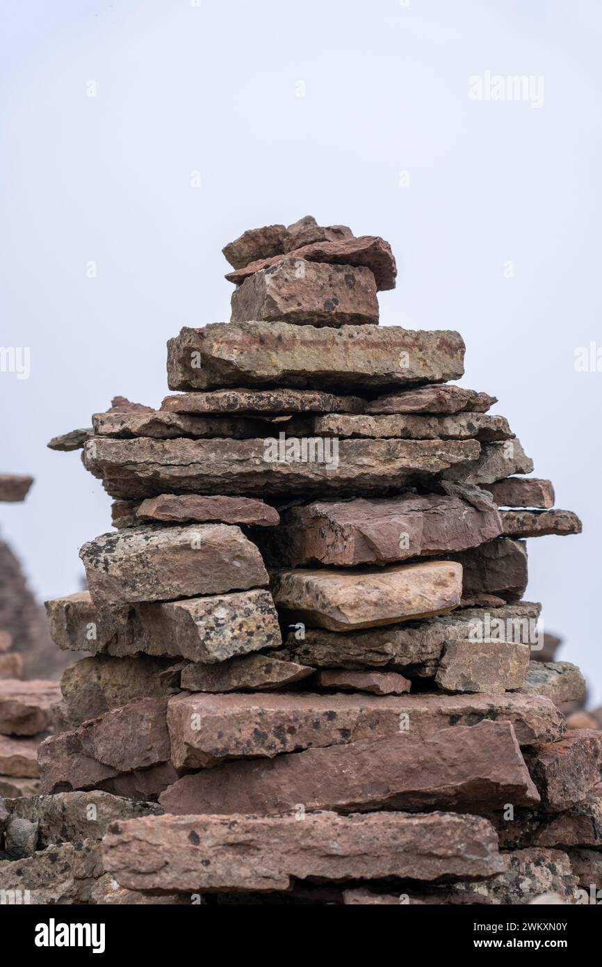 A stack of rocks atop a rocky climb Stock Photo - Alamy