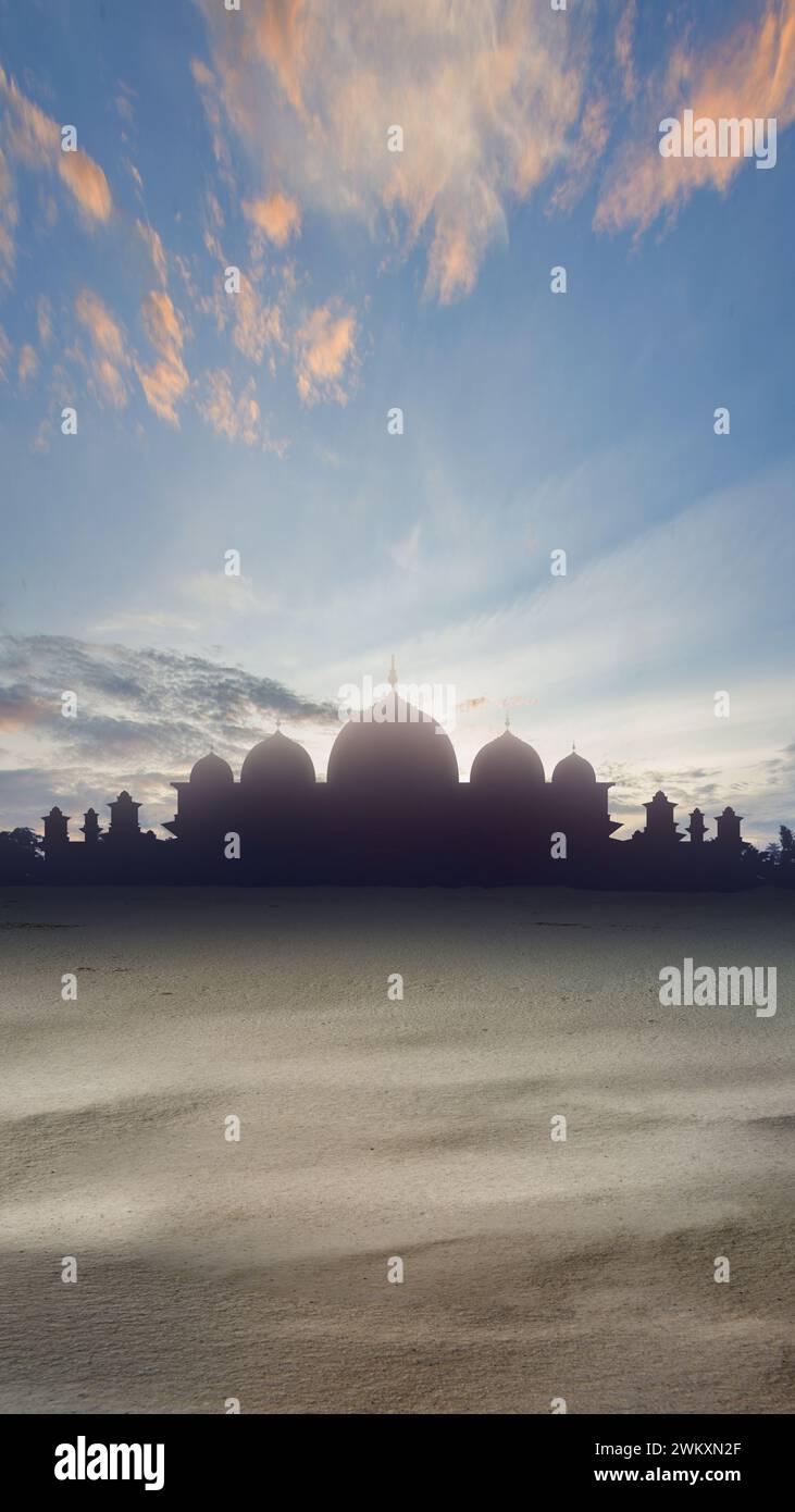 Desert with a view of a silhouette of the mosque with a dramatic sky ...