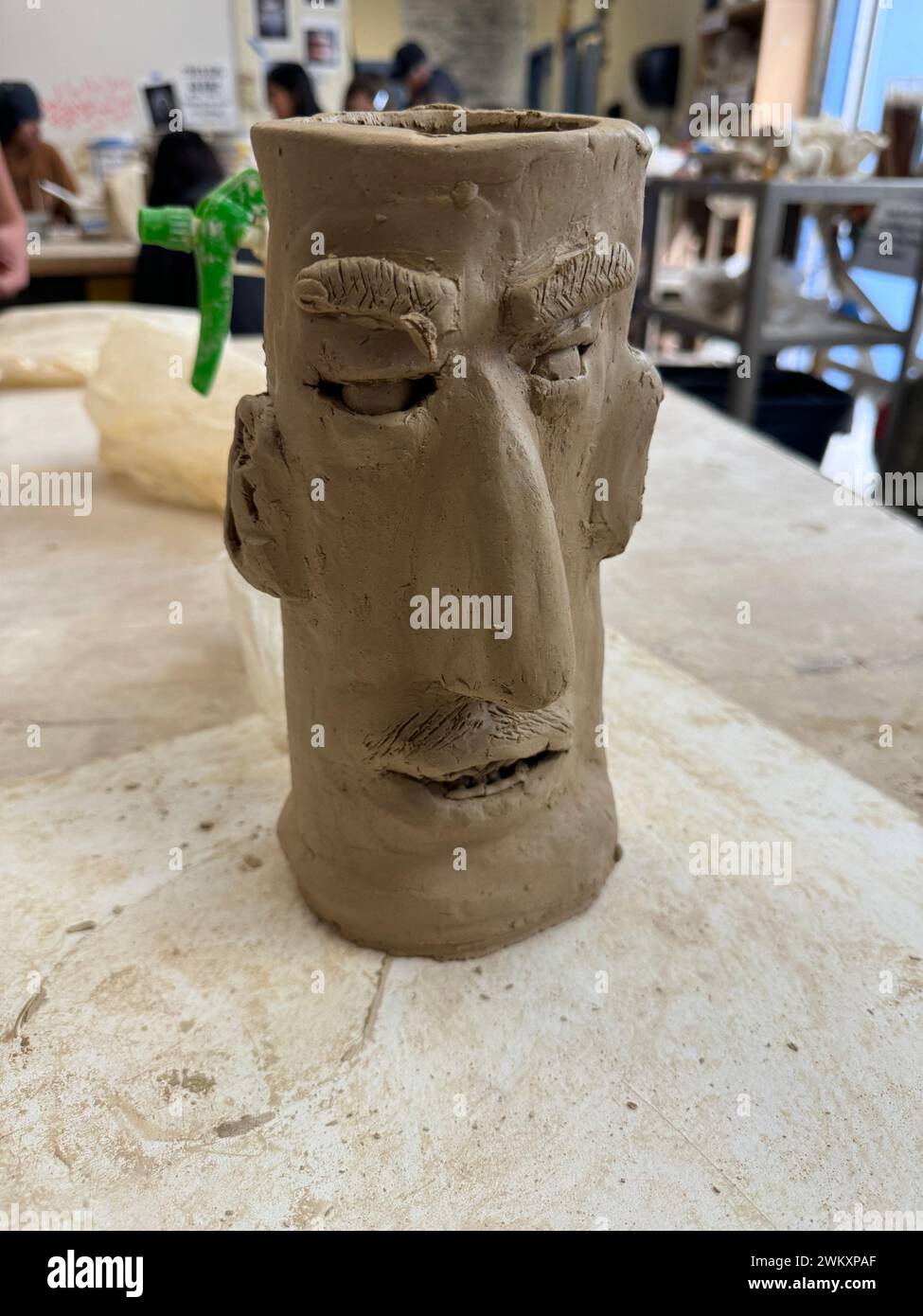 Two clay objects on a counter, one placing the other Stock Photo - Alamy