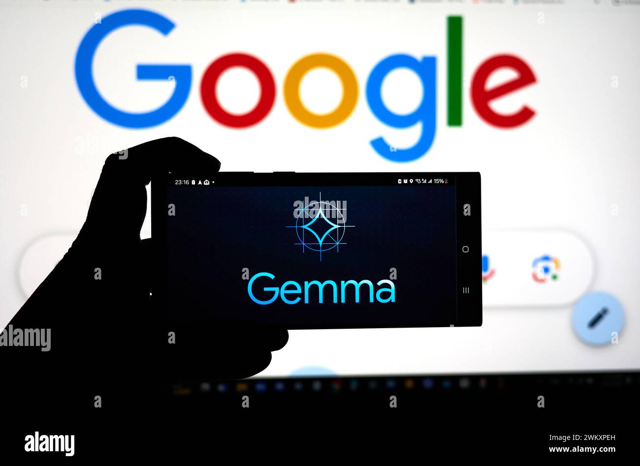 A hand holding a cellphone with Google Gemma logo over Google screen Stock Photo - Alamy
