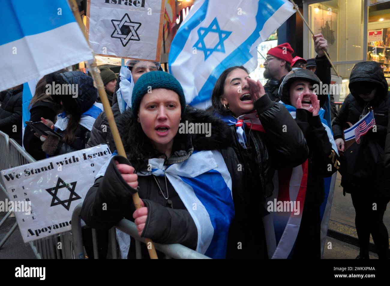 Pro-Israel demonstrators chant slogans and wave Israeli flags across ...