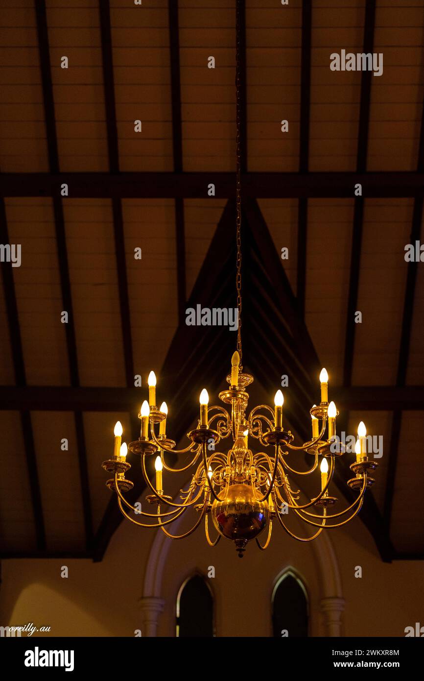 Nighttime view of a vintage church interior with a glowing chandelier ...