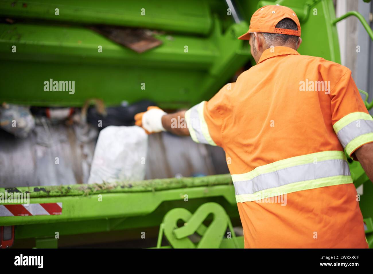 Man, garbage truck and dirt collection on street or recycling pollution ...