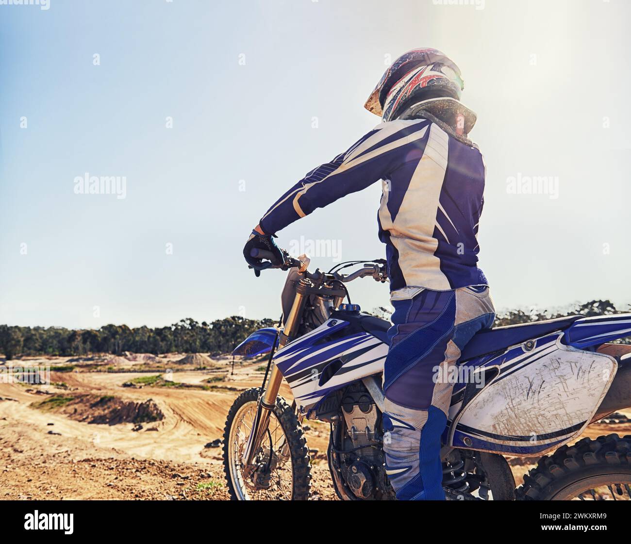 Motorbike, sports and danger with back view of biker person outdoor ...