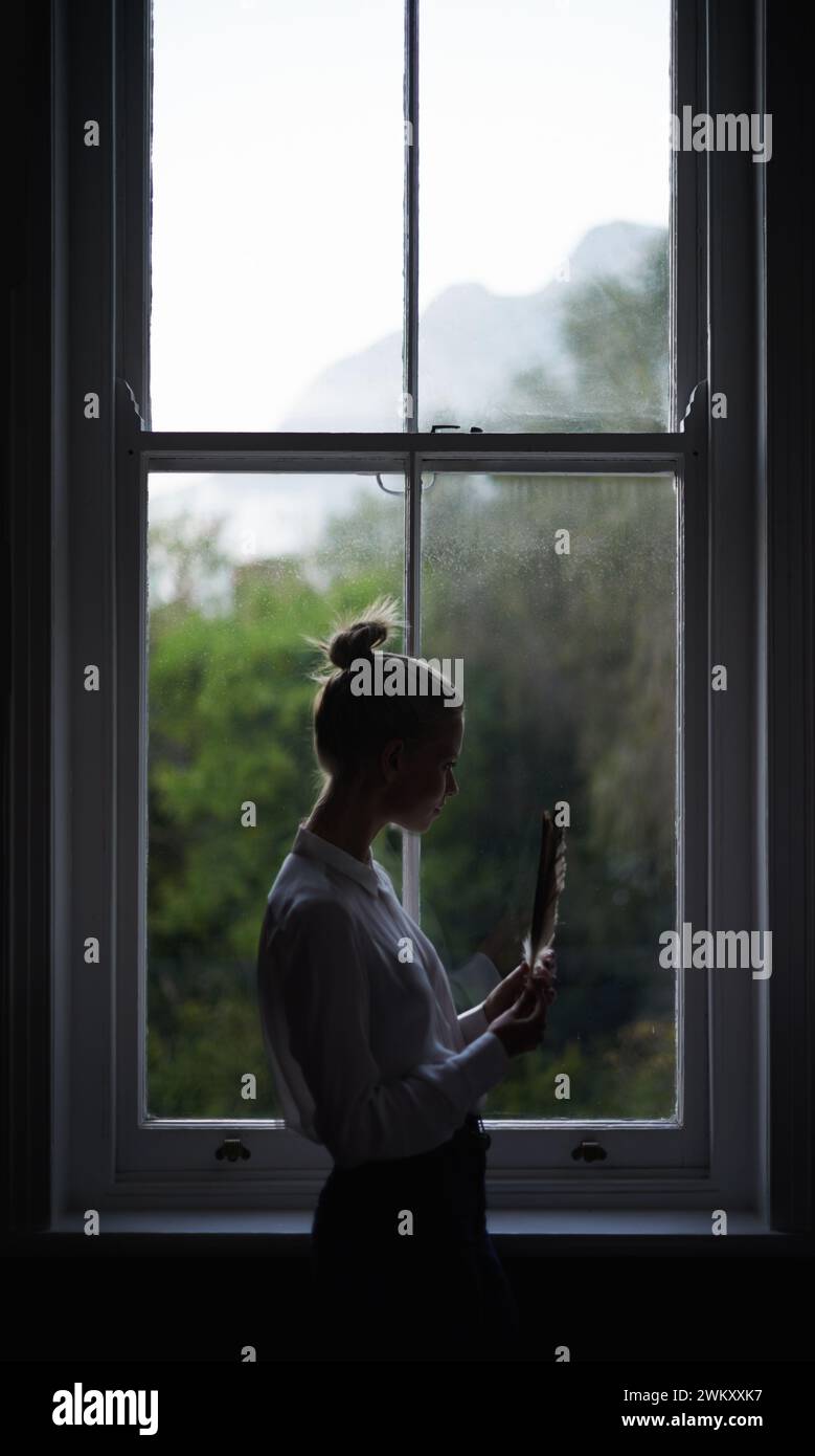 Woman, feather and window for writer in home for idea and creative with ...