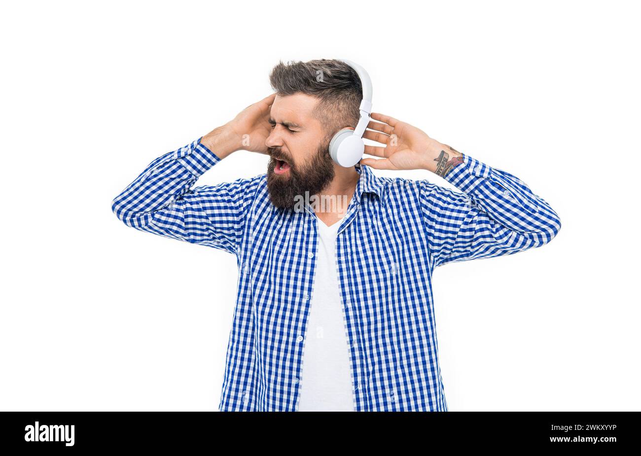 Millennial hipster man listen to music in headphones. Loud music. Man ...