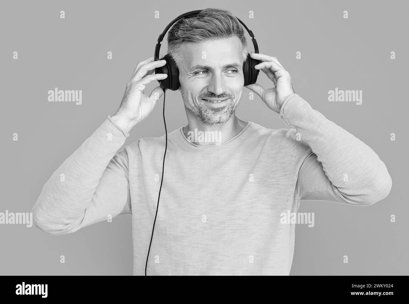 Positive Man Listen Music In Headphones Isolated On Blue Man Listen