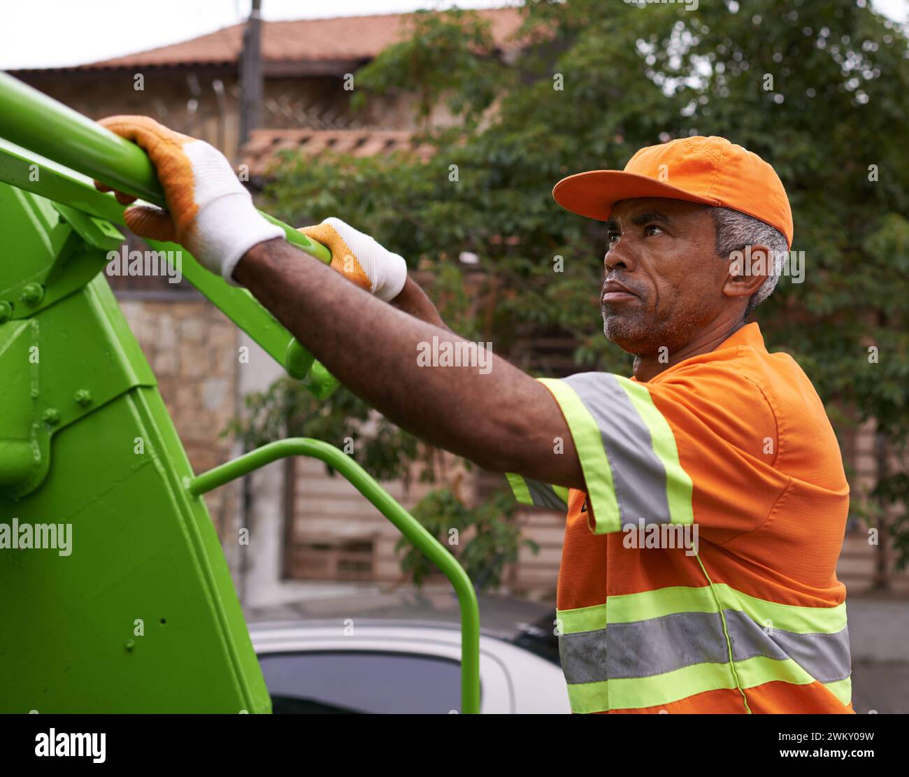 City, worker and man with garbage truck for trash, waste management and ...