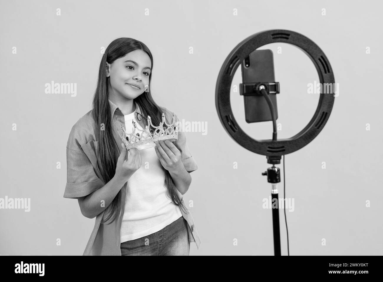 cheerful teen girl influencer with crown in studio. teen girl ...