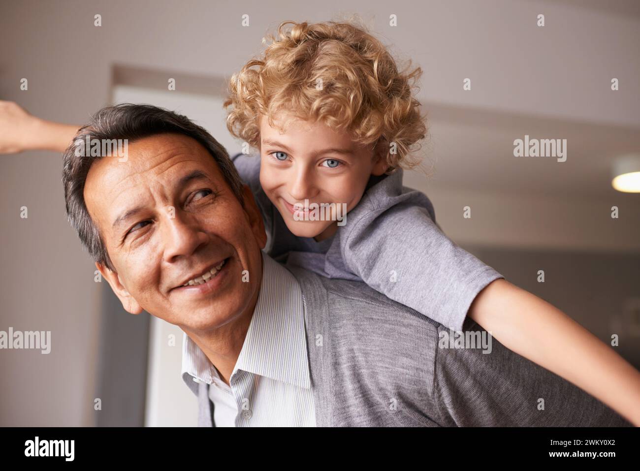Portrait, man and child with piggyback for multiracial family, bonding ...
