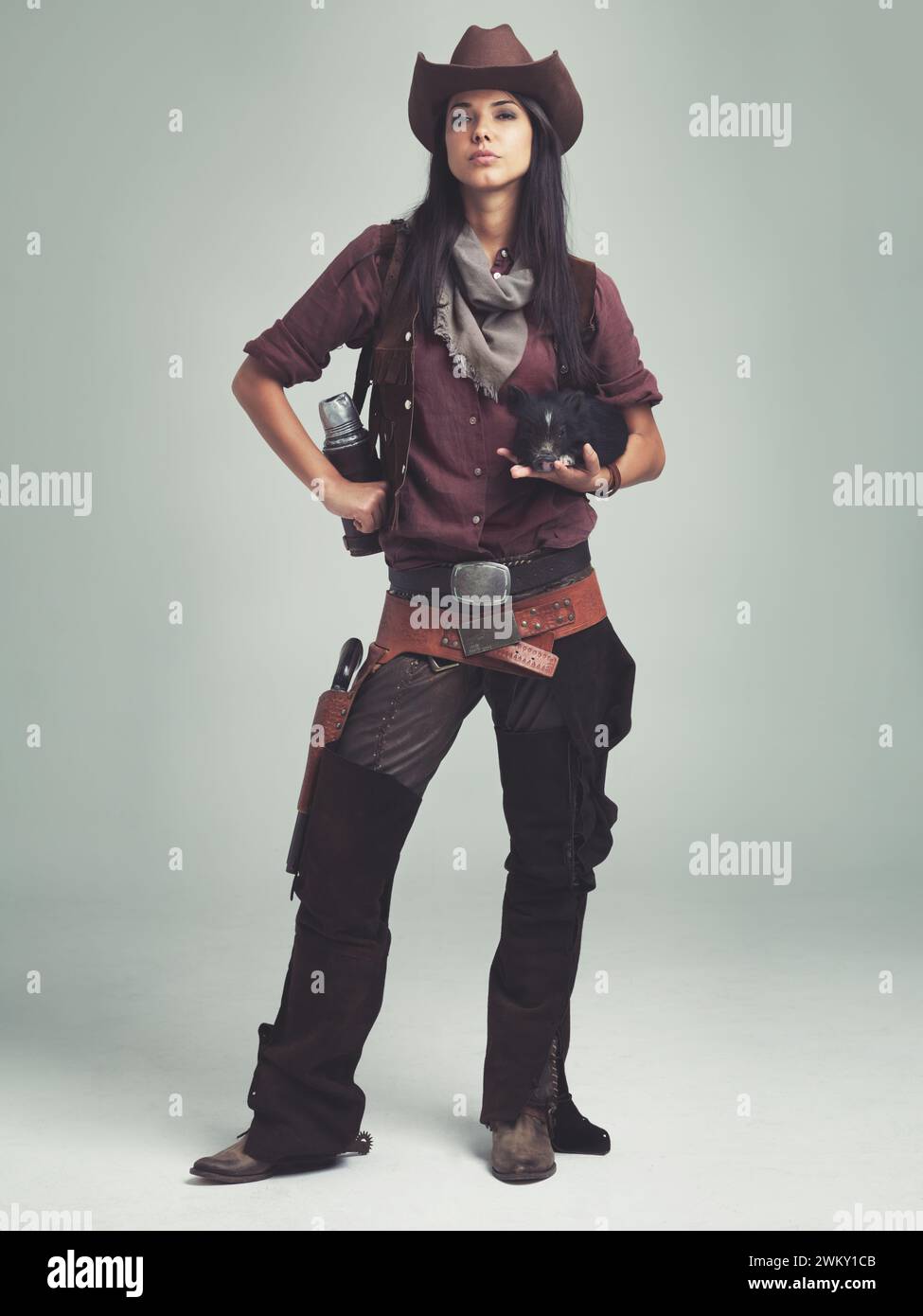 Woman, fashion and cowboy clothes, confident in portrait in studio ...
