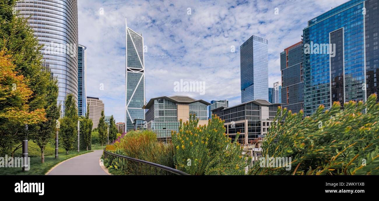 View of a downtown skyscrapers with trees and a path in a park in the ...