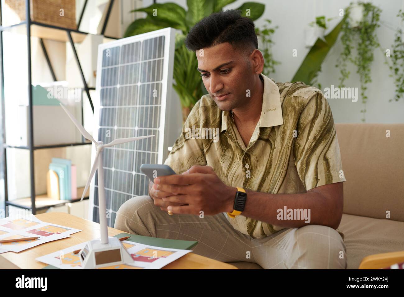 Renewable energy sales manager answering text messages from clients ...