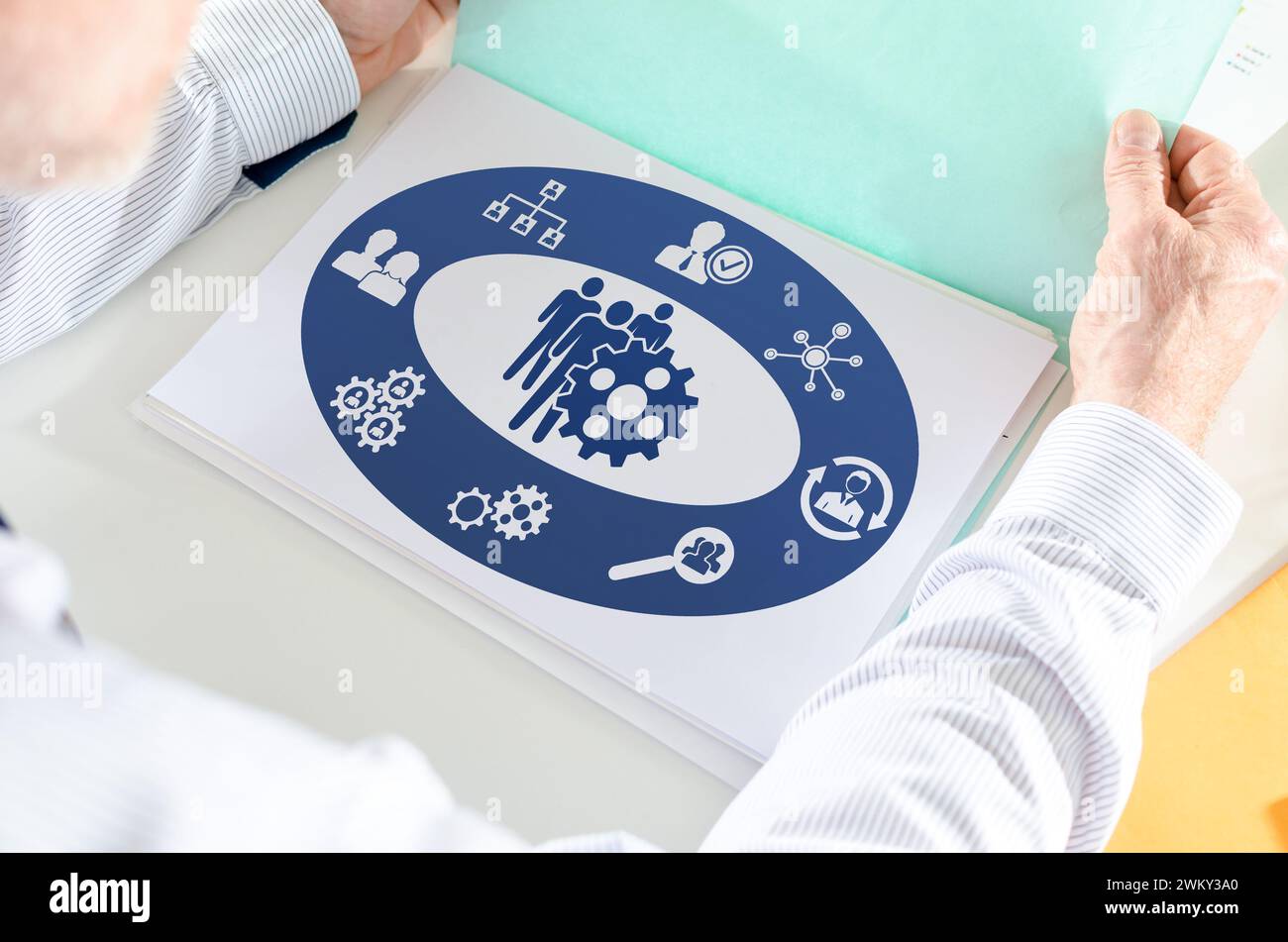 Man holding a file with hrm concept Stock Photo - Alamy