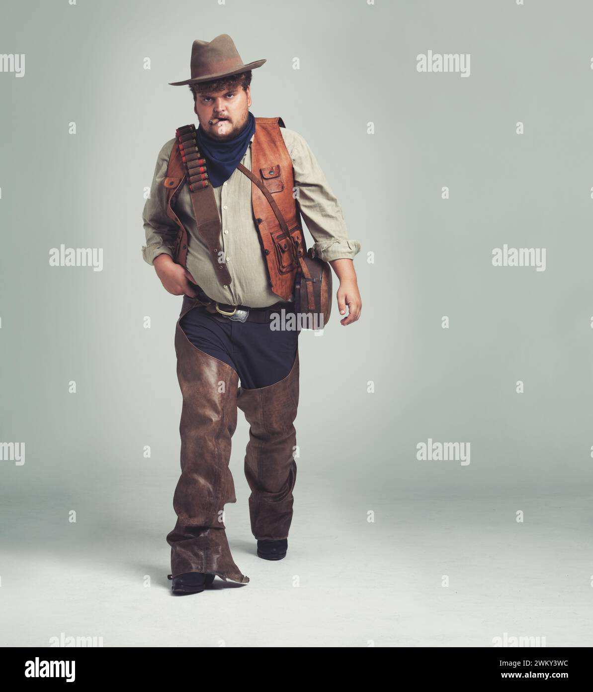 Portrait, serious and criminal cowboy in studio mockup, outlaw and wild ...