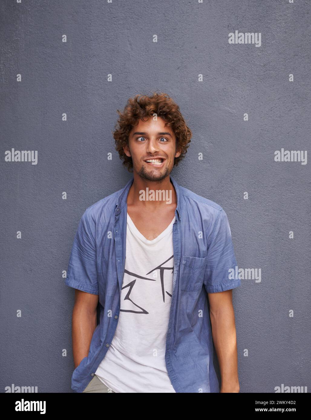 Crazy, funny and portrait of young man by wall for comic, playful or ...
