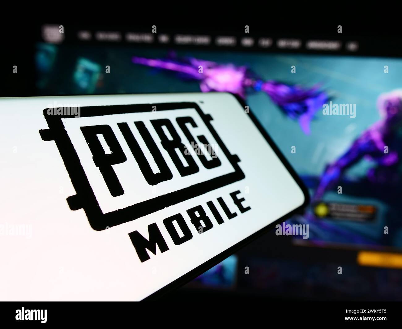 Mobile phone with logo of battle royale video game PUBG Mobile in front of company website ...