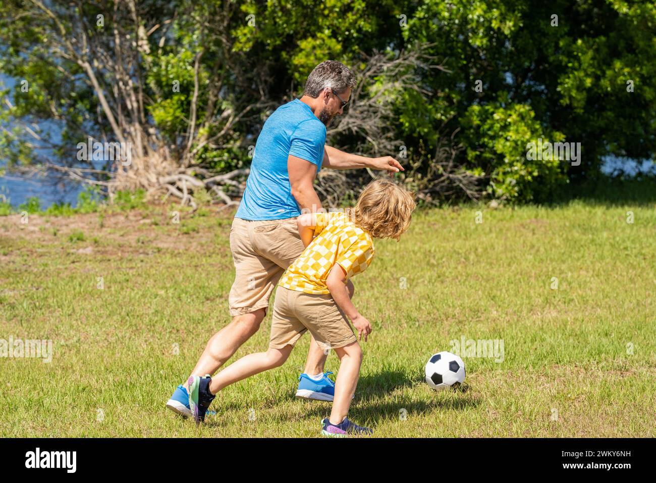 dad and son playing football during their childhood. Childhood memories ...