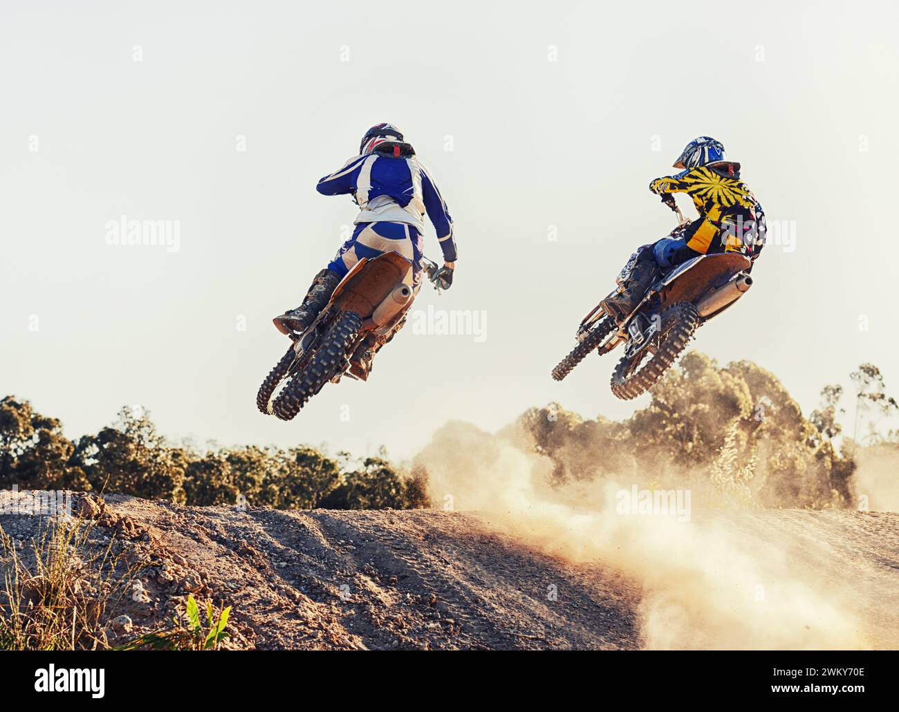 Sport, racer and dirtbike in action for competition on dirt road with ...