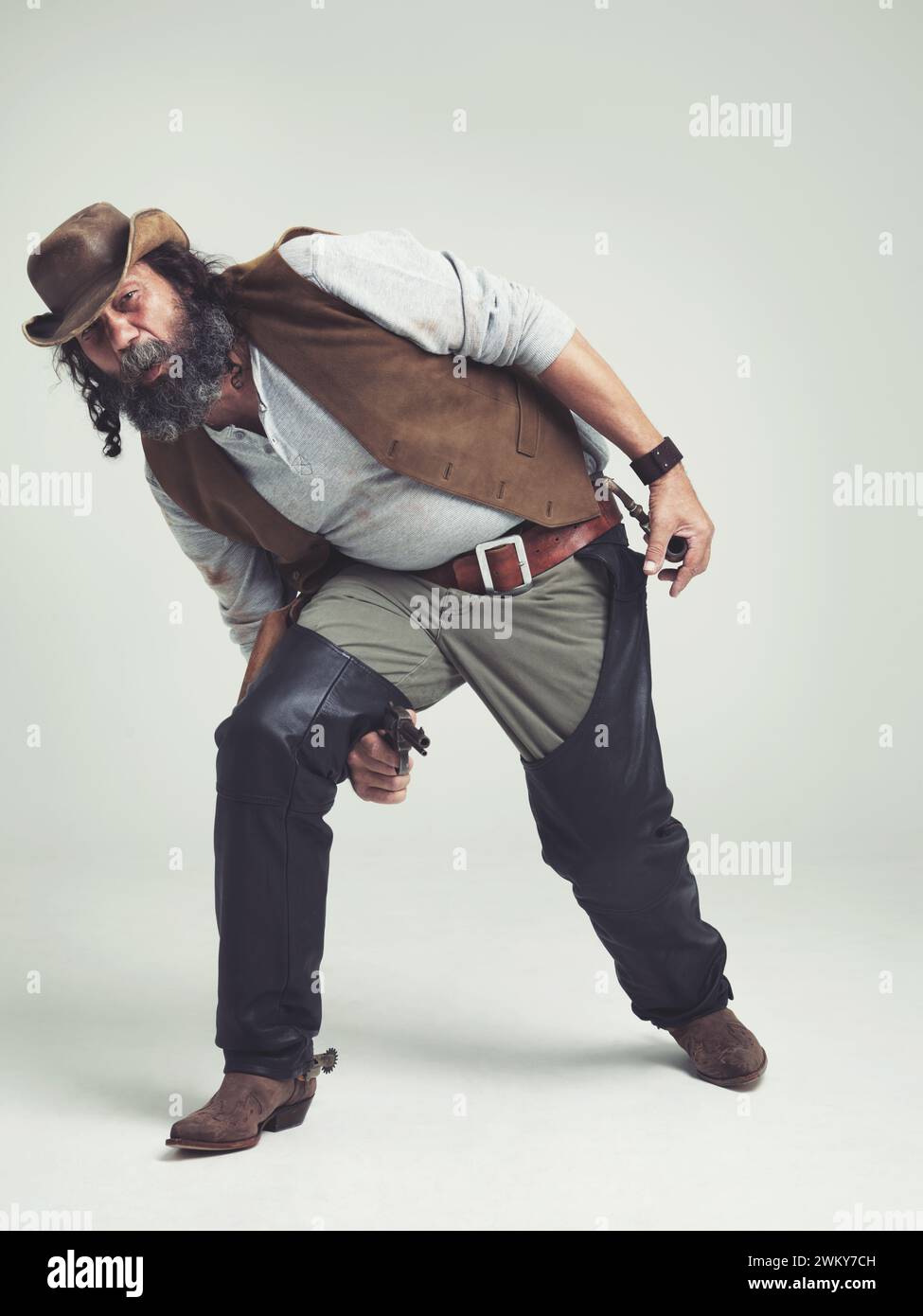 Portrait, cowboy and character with gun in studio mockup, outlaw and ...