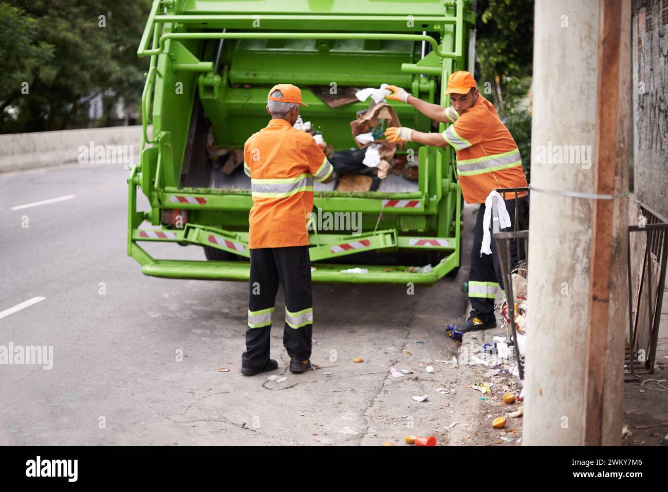 Men, garbage truck and city sidewalk for collection service for public ...