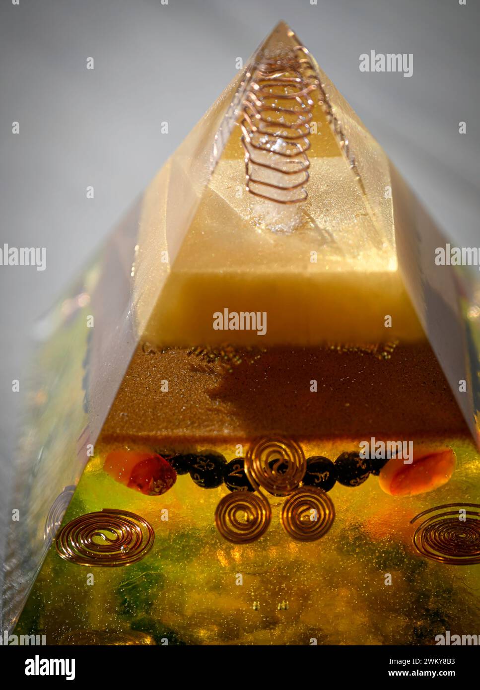 Isolated close up of three beautiful blue orgone generator pyramids ...