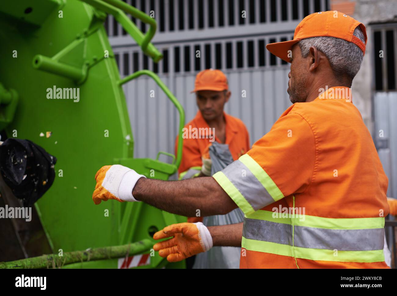 City, trash and people with garbage truck working in waste management ...