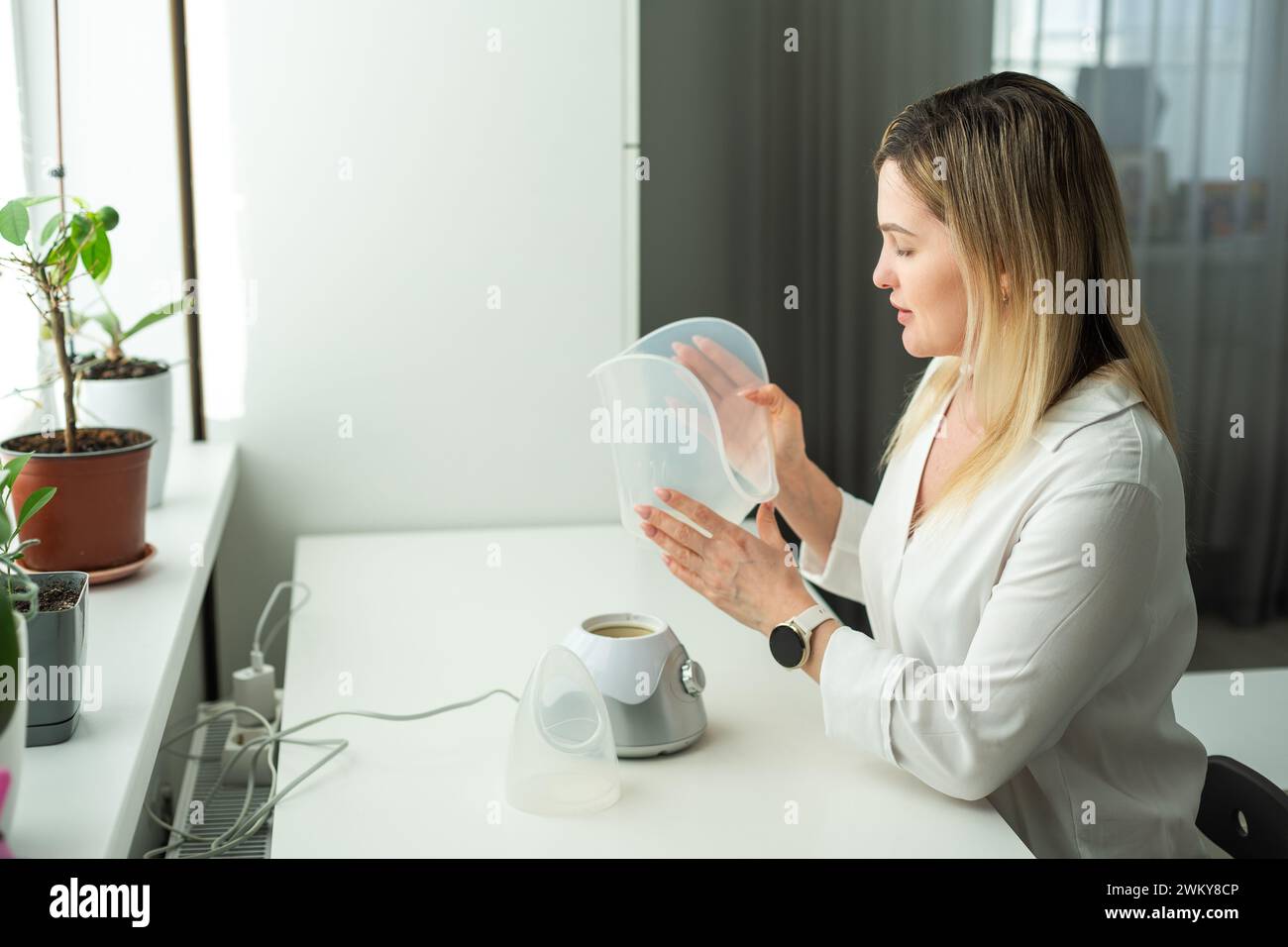 Young woman doing inhalation with a medical vaporizer nebulizer machine ...