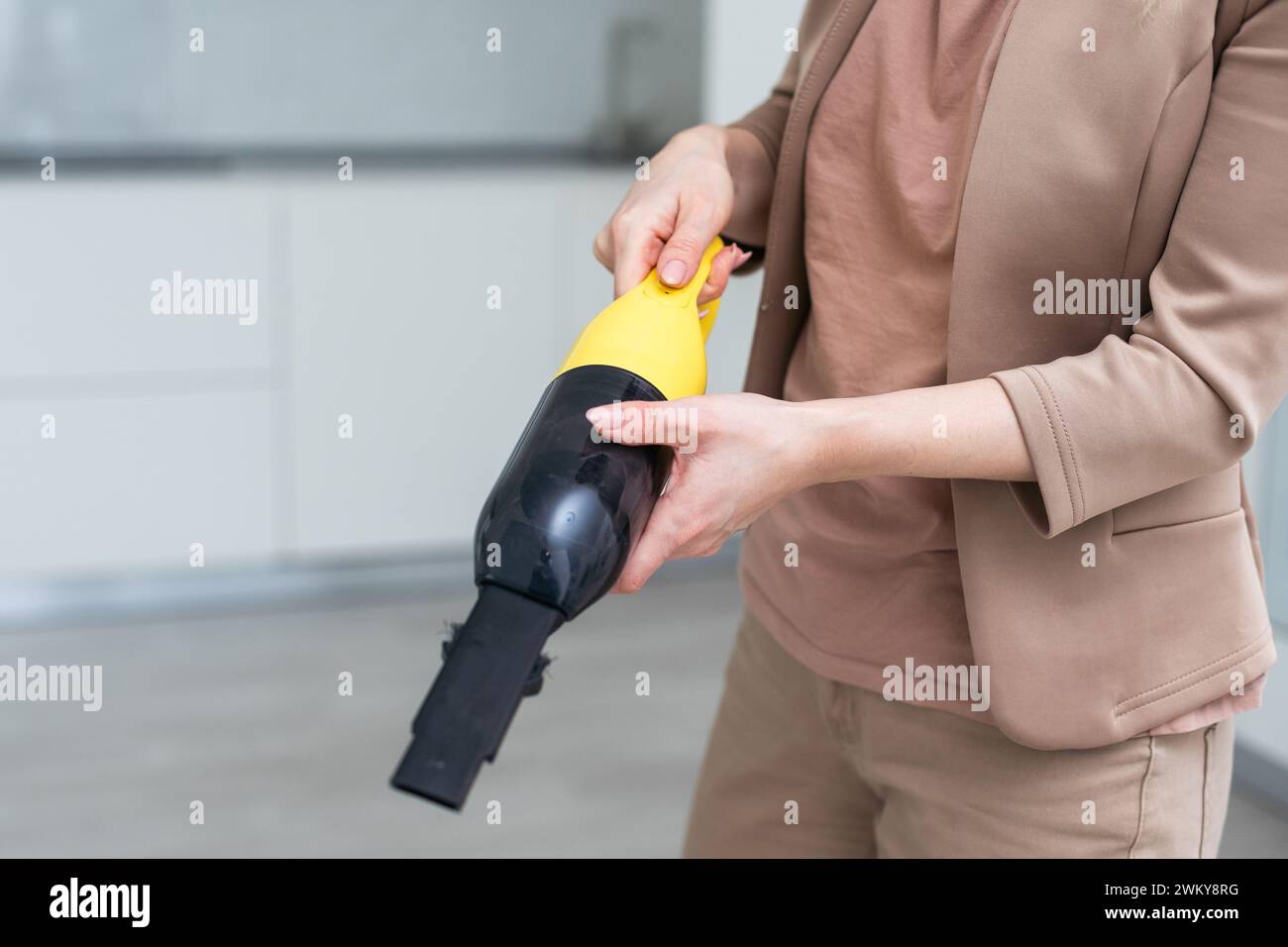 Female hand holding a portable vacuum cleaner cleaning the house ...