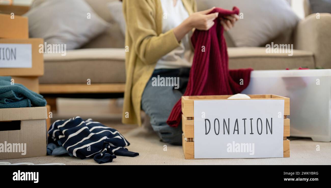 Donation, asian young woman sitting pack object at home, putting on ...