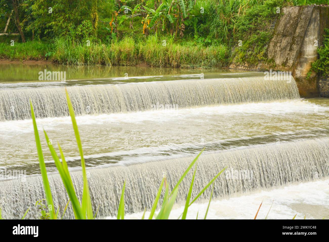 A fast-flowing stream and dramatic lenticular clouds against a dark sky ...