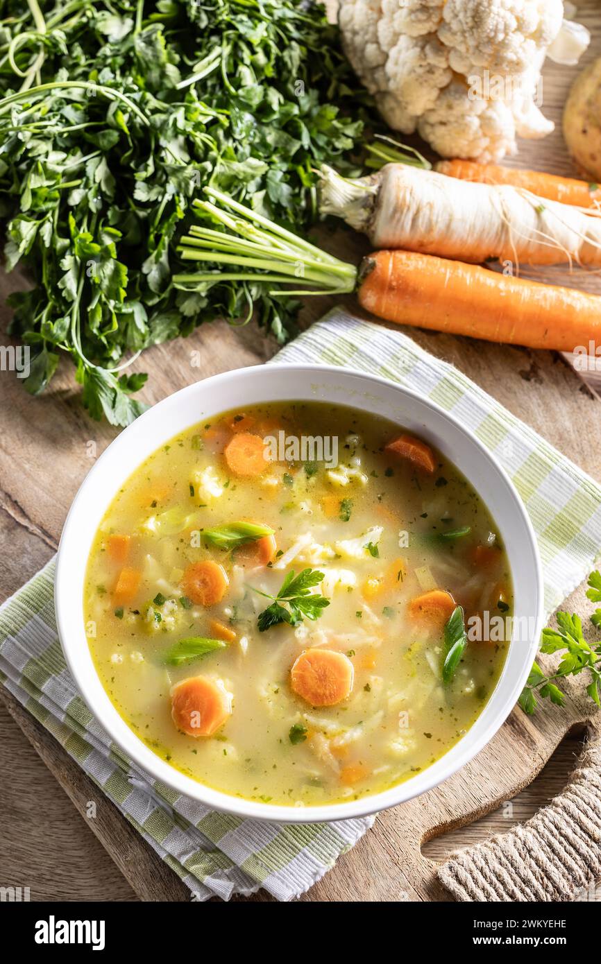 Spring vegetable soup with chopped and grated root vegetables, seasoned ...