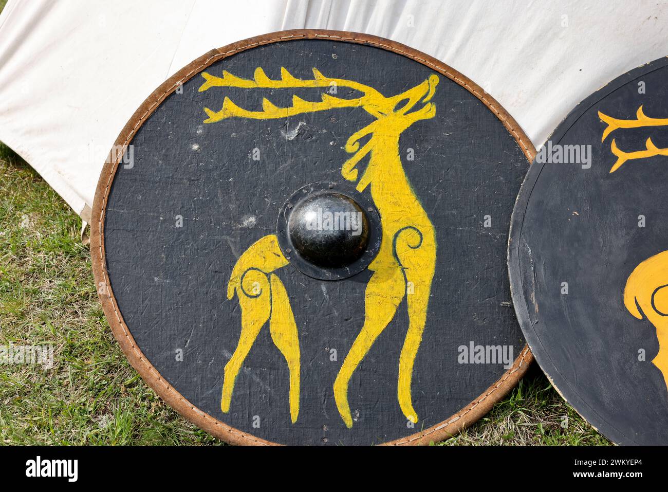 Medieval weapons, shields in knight camp at the festival of historical ...