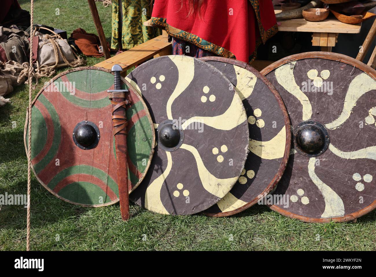 Medieval weapons, shields in knight camp at the festival of historical ...
