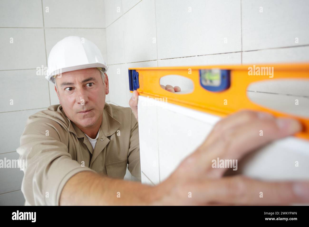 man repair man measuring kitchen cabinet Stock Photo - Alamy