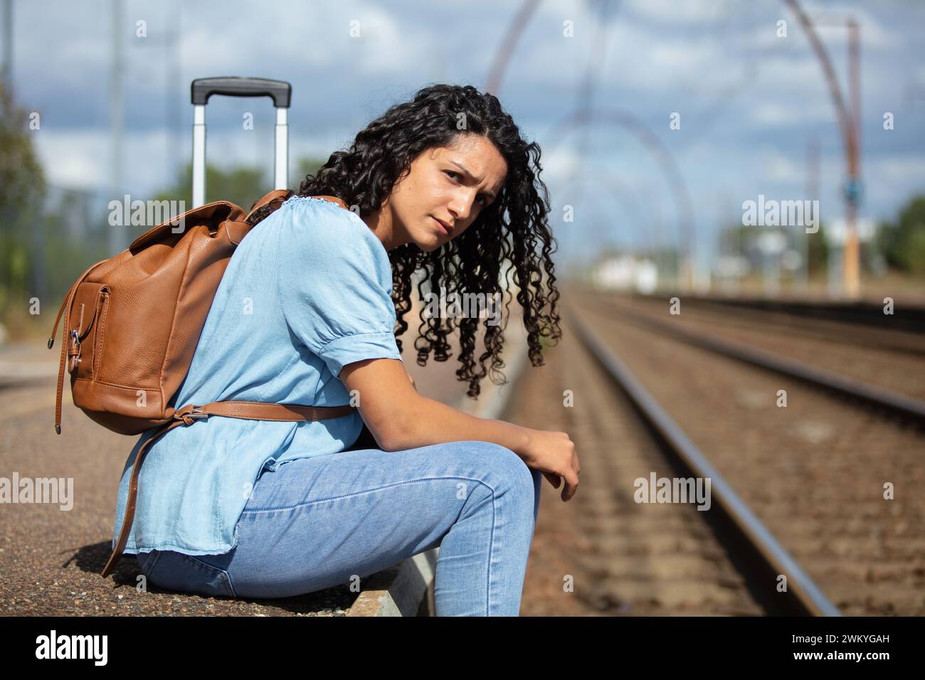 sad woman traveler waiting for the train on platform Stock Photo - Alamy