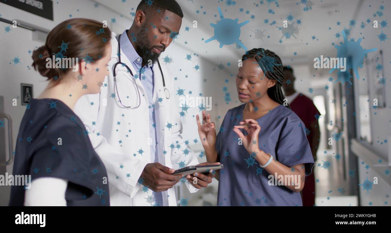 Image of floating viruses over diverse doctors talking in hospital ...