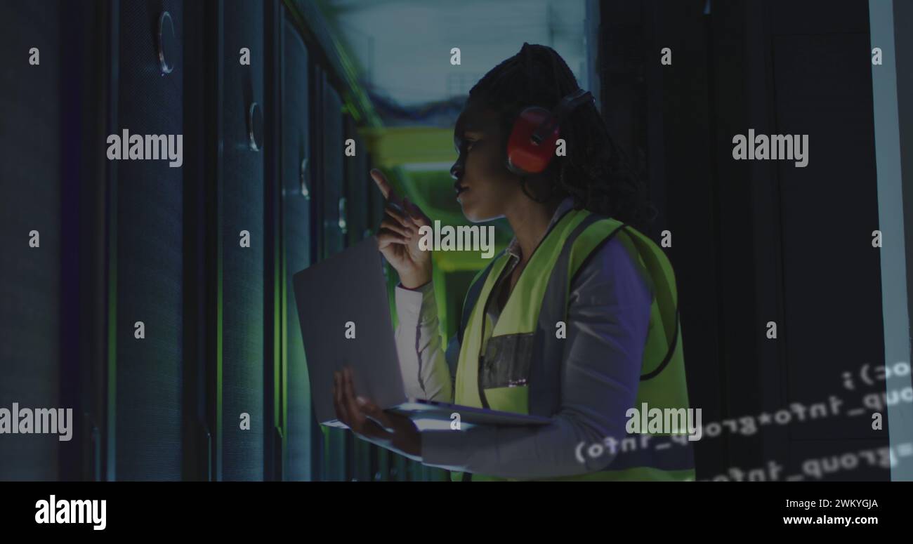 African american female server room worker using headphones Stock Photo ...