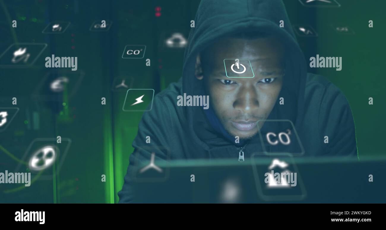 Image of falling icons over african american hacker Stock Photo - Alamy