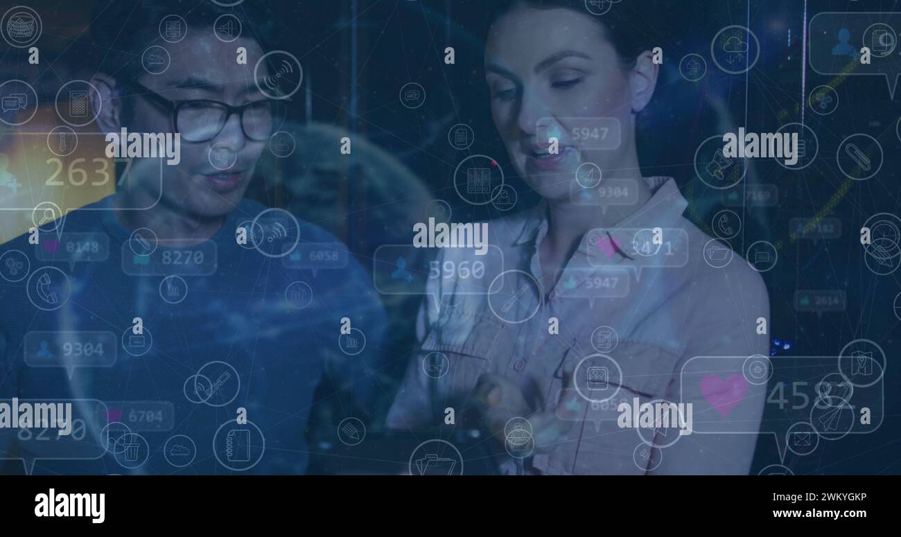 Image of social media icons over diverse couple of server room workers ...