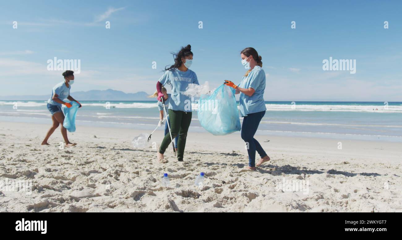 Volunteers clean up a beach, with copy space Stock Photo - Alamy