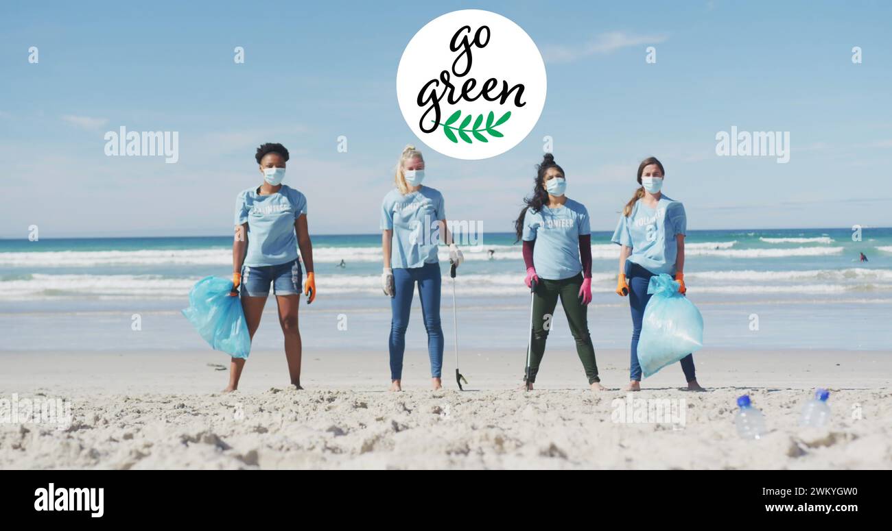 Image of go green text and logo over happy diverse group wearing face ...
