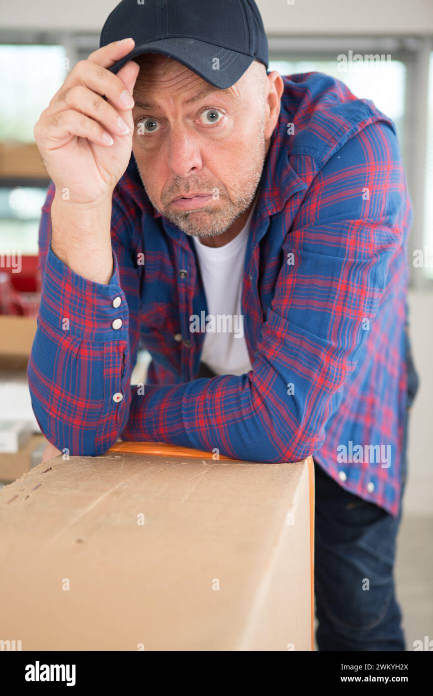 Tired delivery man box hi-res stock photography and images - Alamy